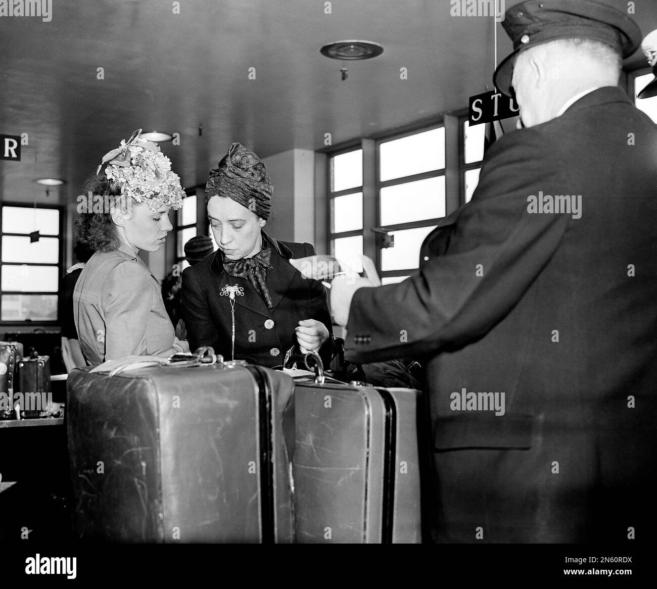 Mme. Elsa Schiaparelli, right, French fashion designer, goes through ...