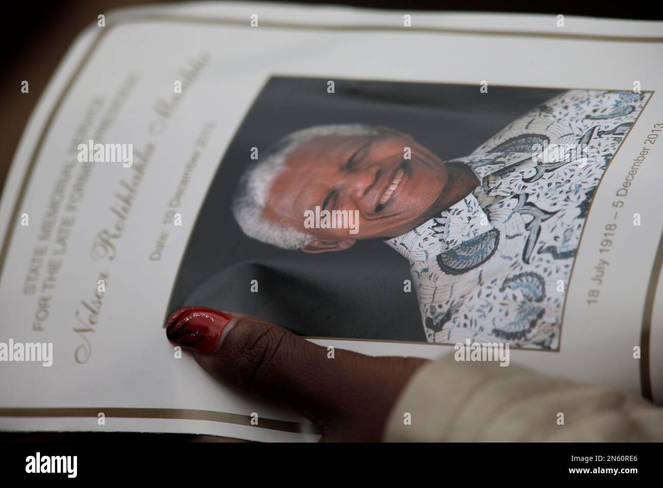 A woman holds the official programme during the memorial service for ...