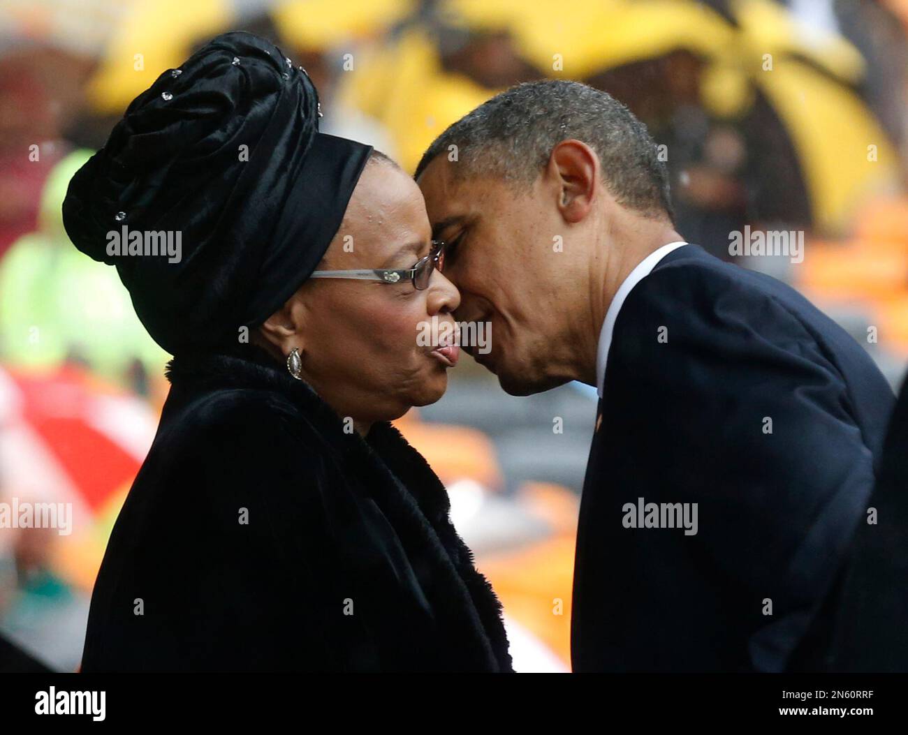 President Barack Obama kisses Nelson Mandela's widow Graca Machel ...