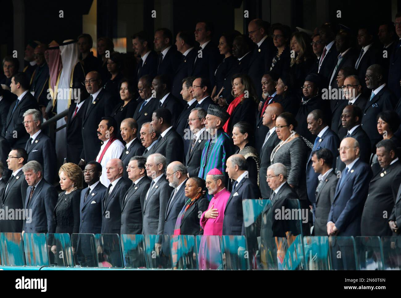 VIP's and dignitaries stand up for the start of the memorial service ...