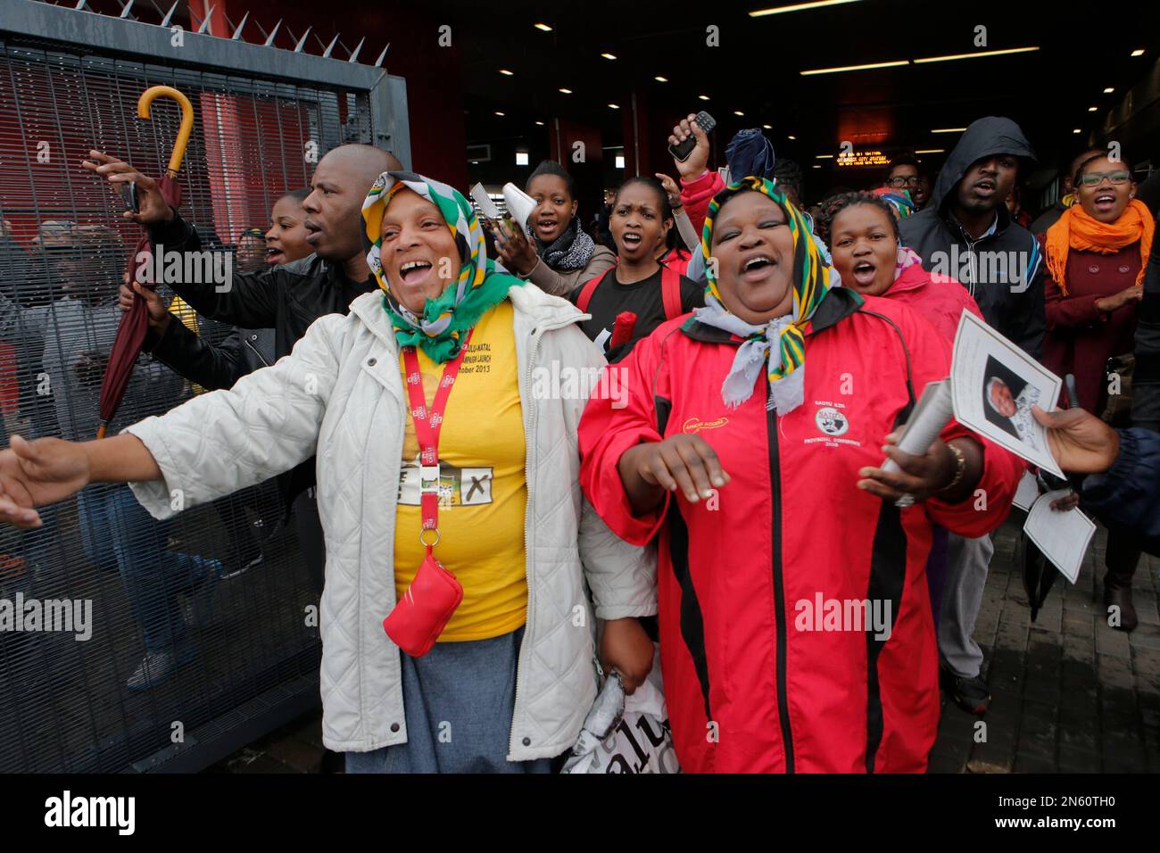 People sing and dance as they arrive for the memorial service for ...