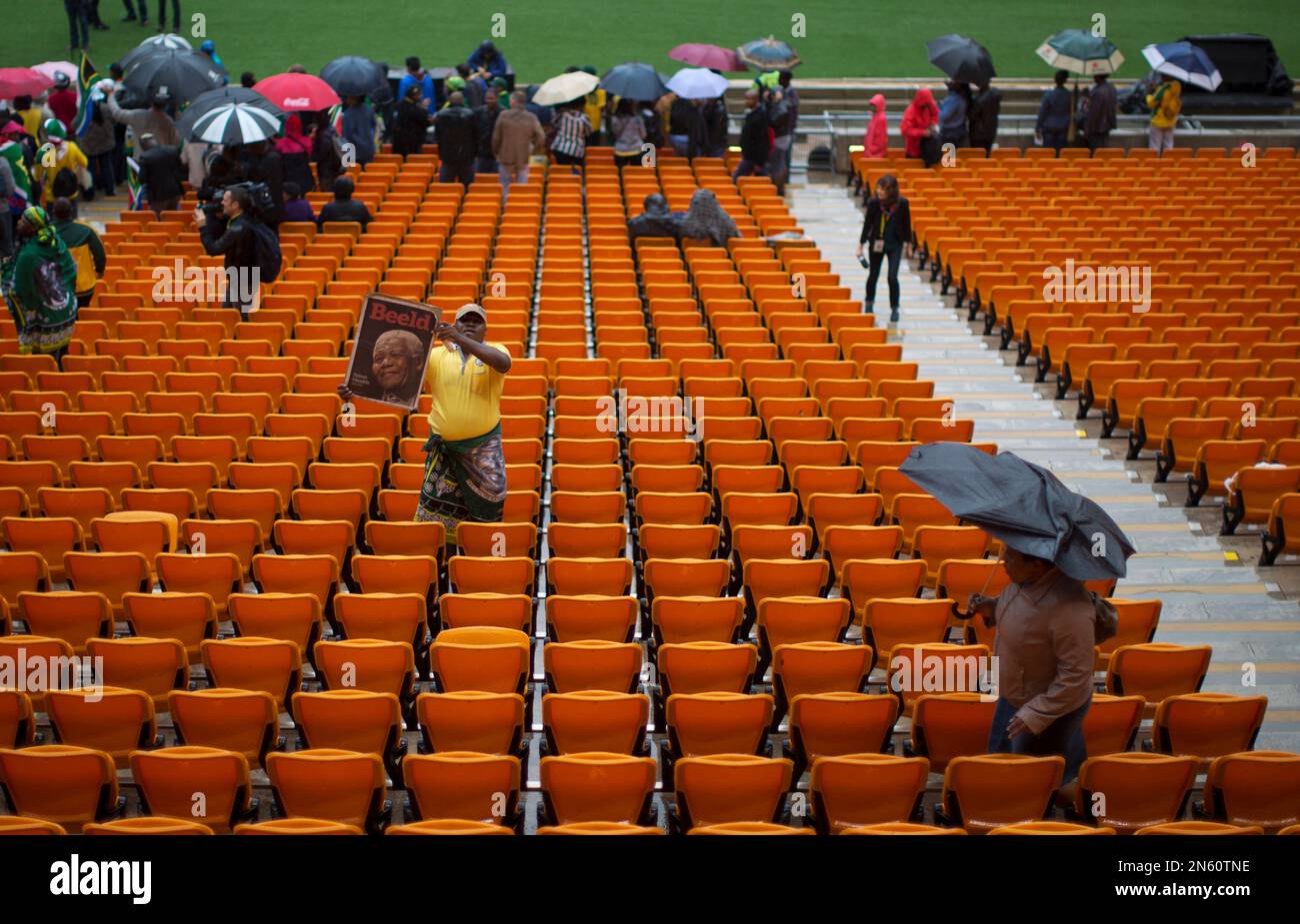A mourner holds a poster of former South African president Nelson ...