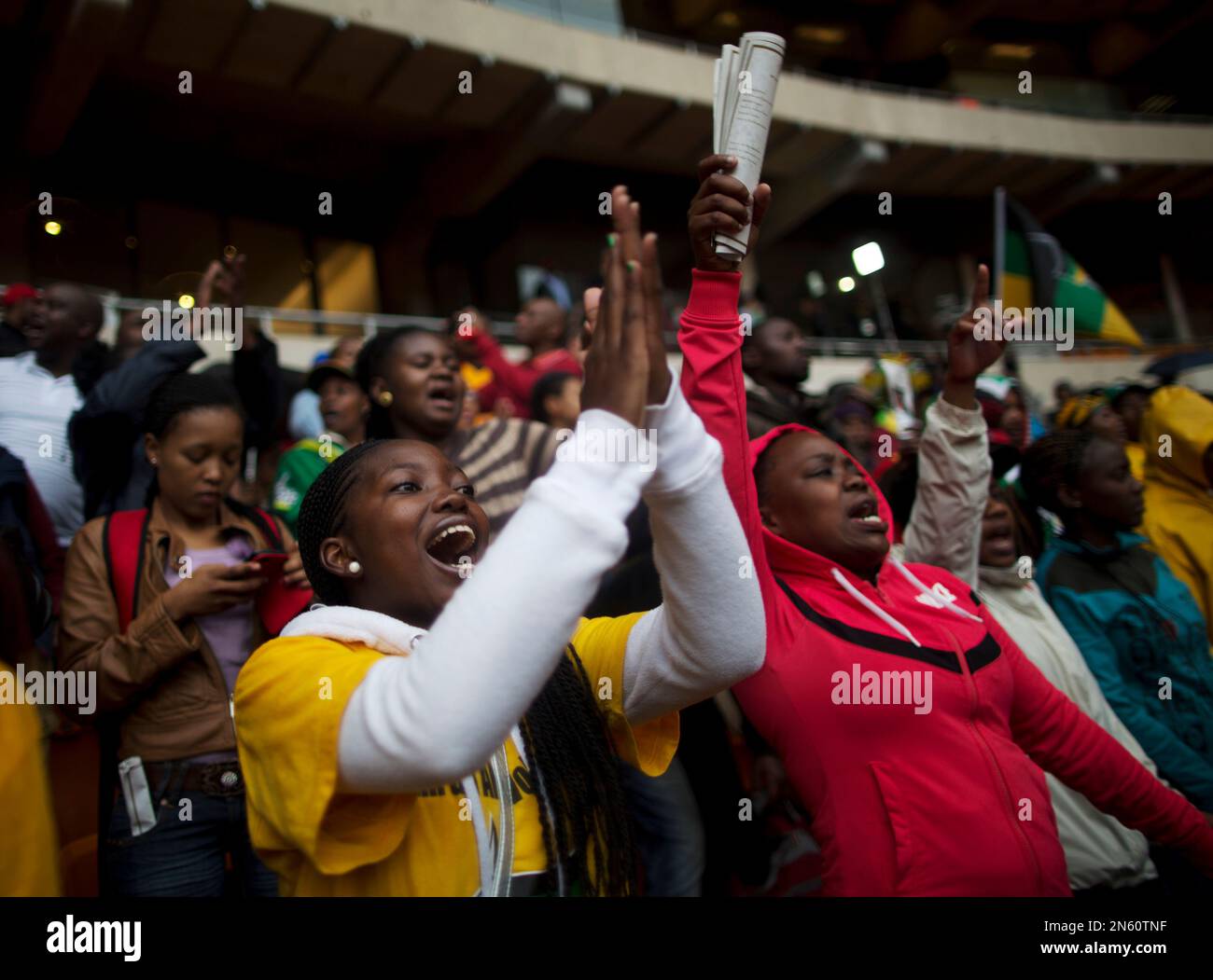Mourners sing inside of FNB Stadium as they wait for the memorial ...