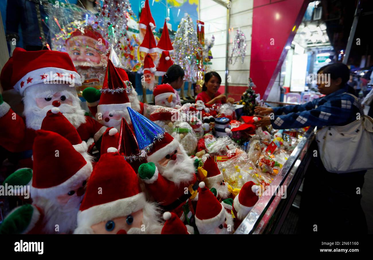 Myanmarese vendor prepares a Christmas display at downtown in Yangon ...