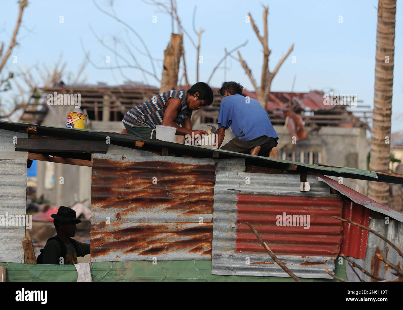 Typhoon survivors build a house from used metal sheets at typhoon ...