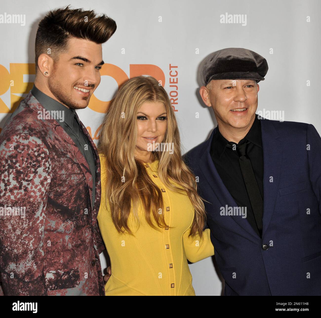 From left, Adam Lambert, Fergie, and Ryan Murphy arrive at TrevorLIVE ...