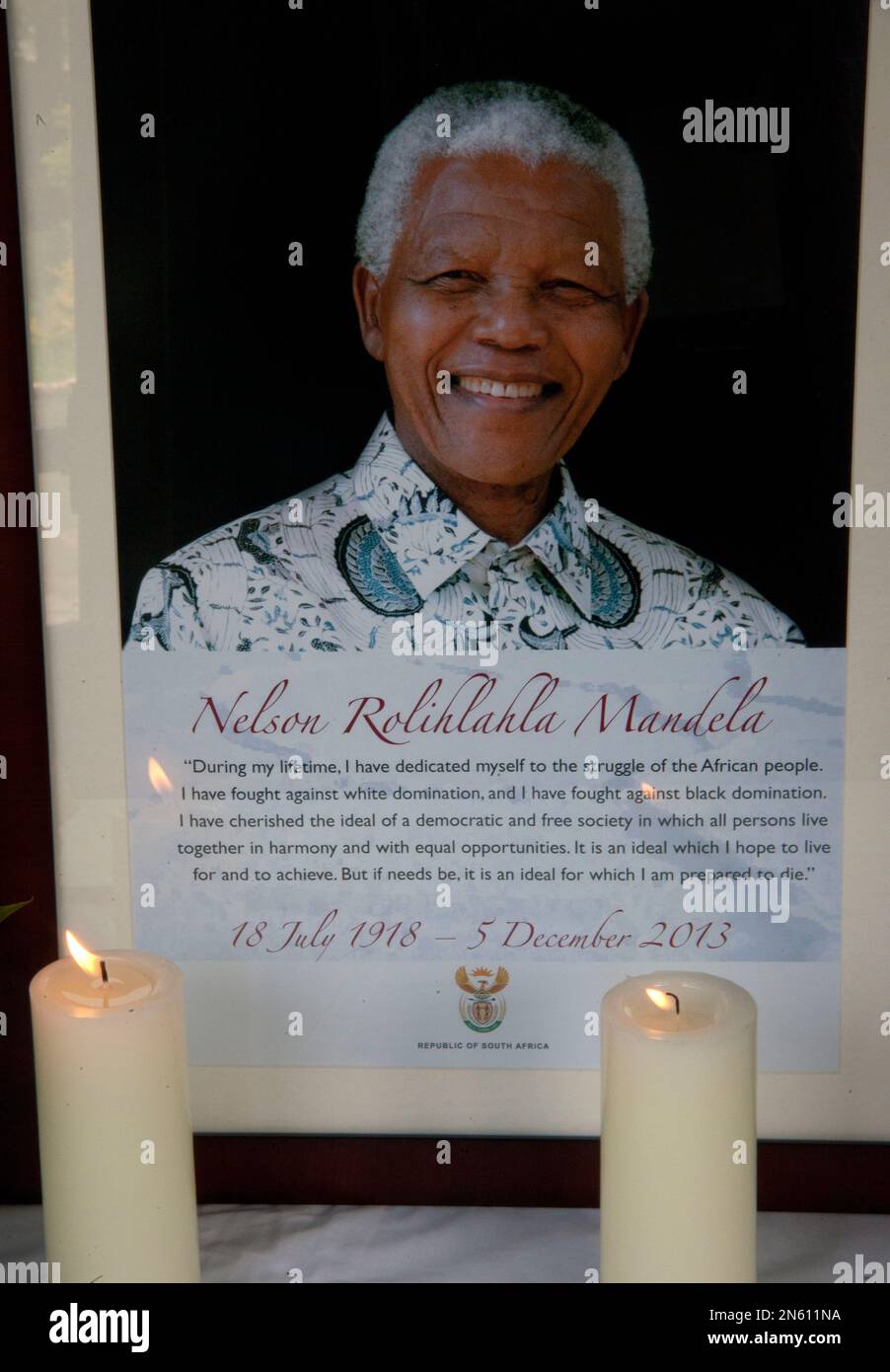 Candles burn in front of a photo of late Nelson Mandela at Kilimani Primary School in Nairobi ...