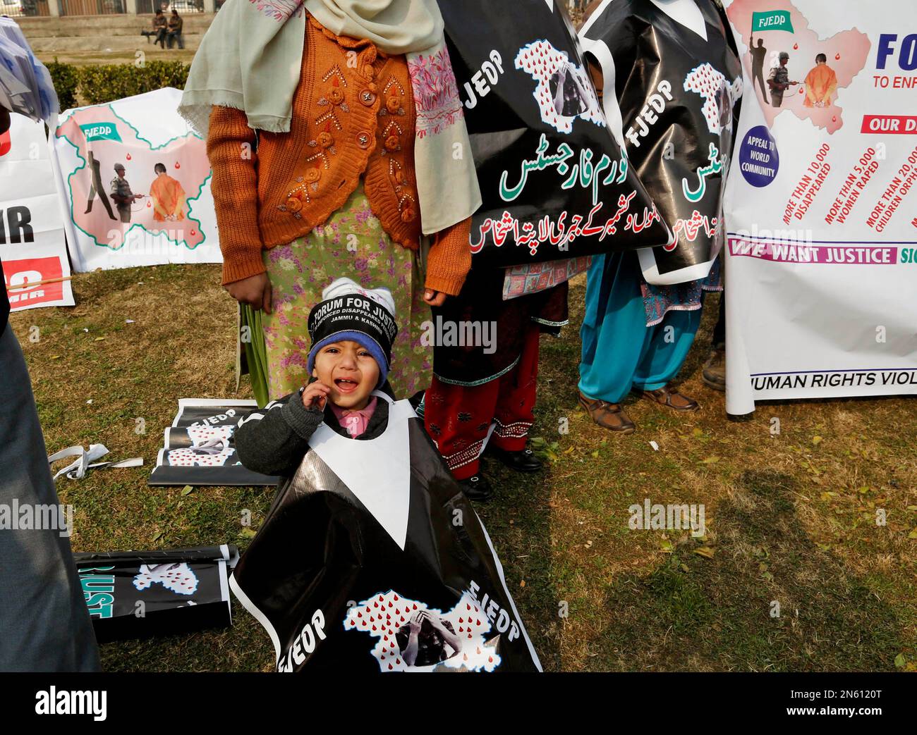 A young child of an activist of Jammu Kashmir Forum for Justice cries ...