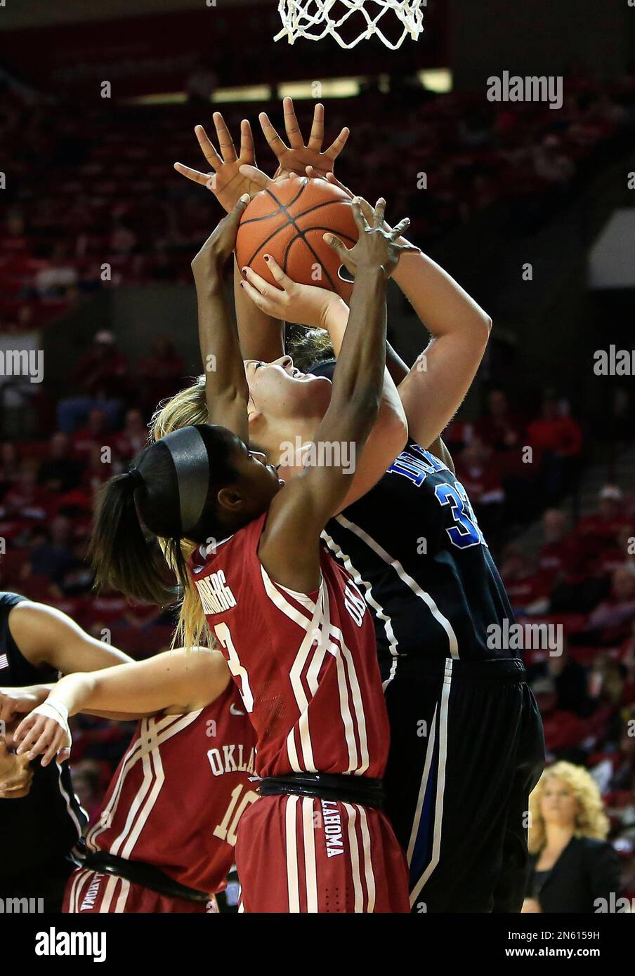 Duke forward Haley Peters, center, goes to the basket between Oklahoma ...