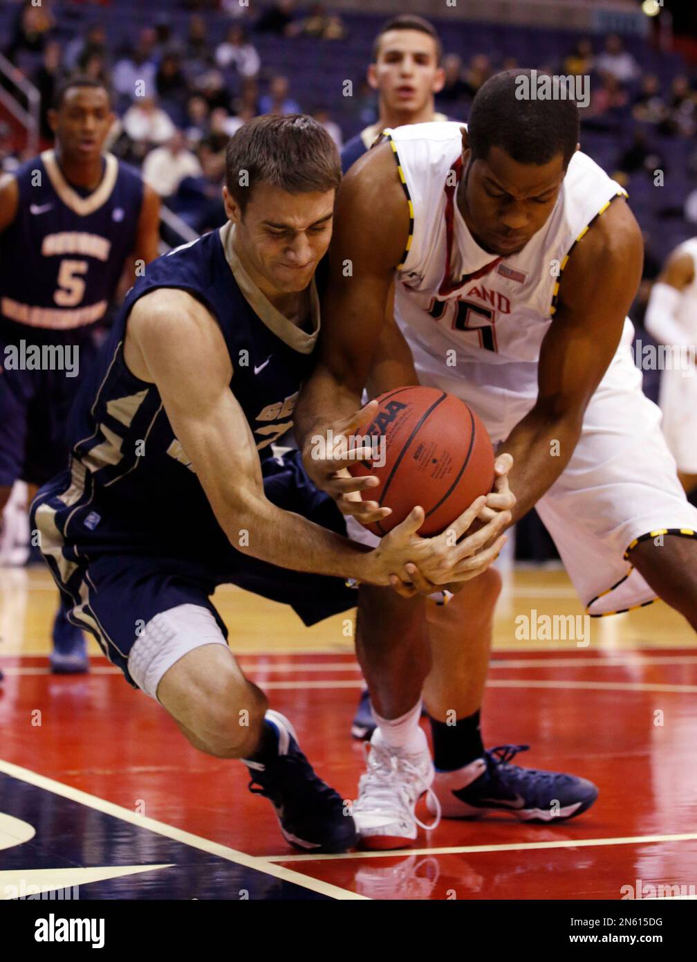 George Washington forward John Kopriva (34) and Maryland forward ...