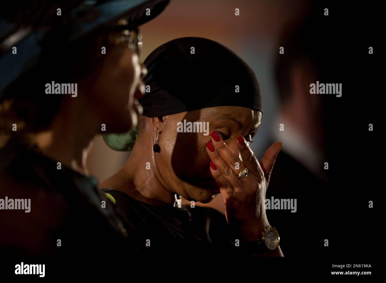 A worshipper wipes her tears during a memorial service for deceased ...