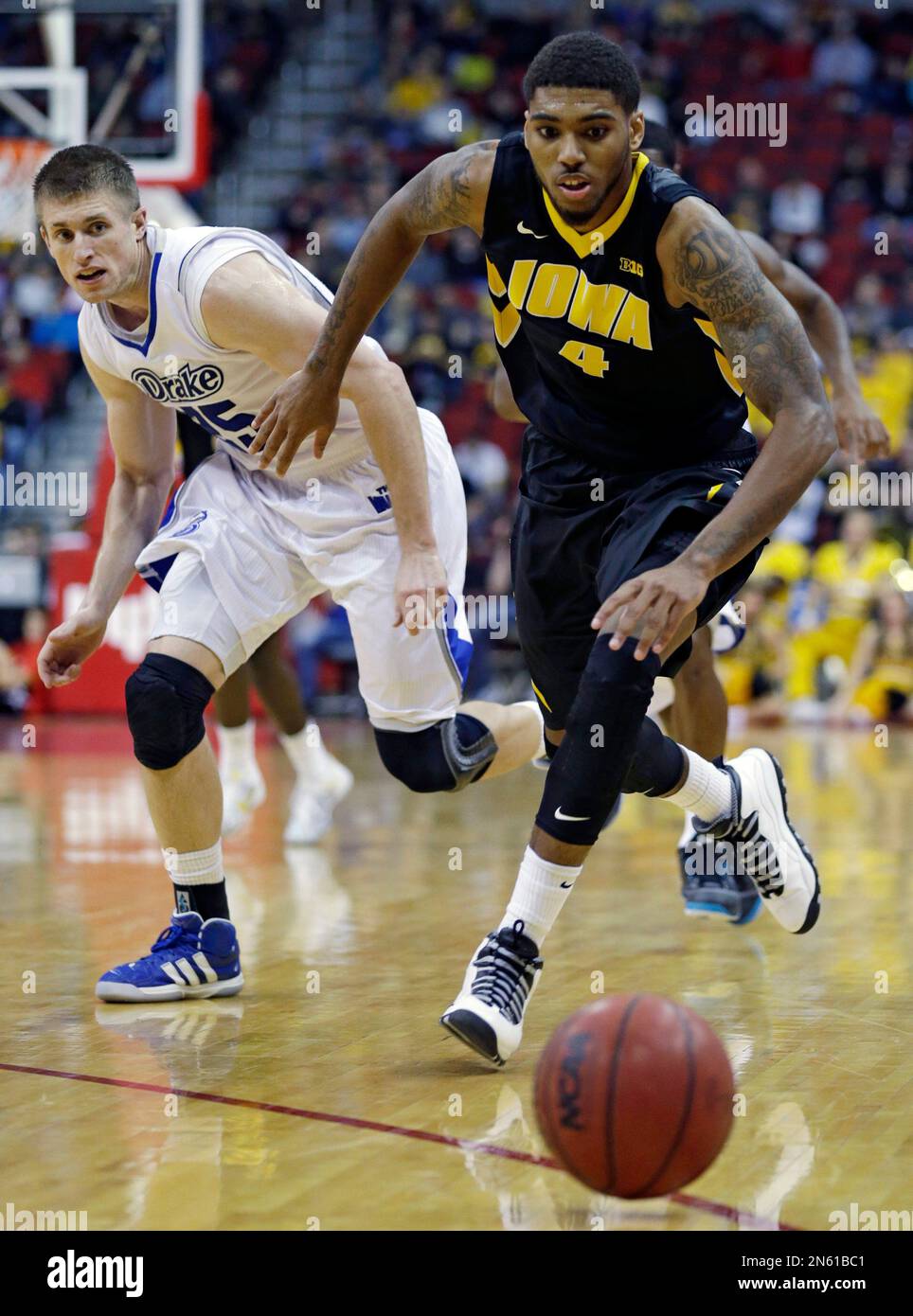 Iowa guard Devyn Marble, right, runs down a loose ball ahead of Drake ...