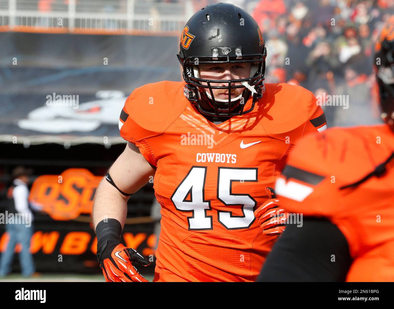 Oklahoma State linebacker Caleb Lavey (45) runs onto the field before ...