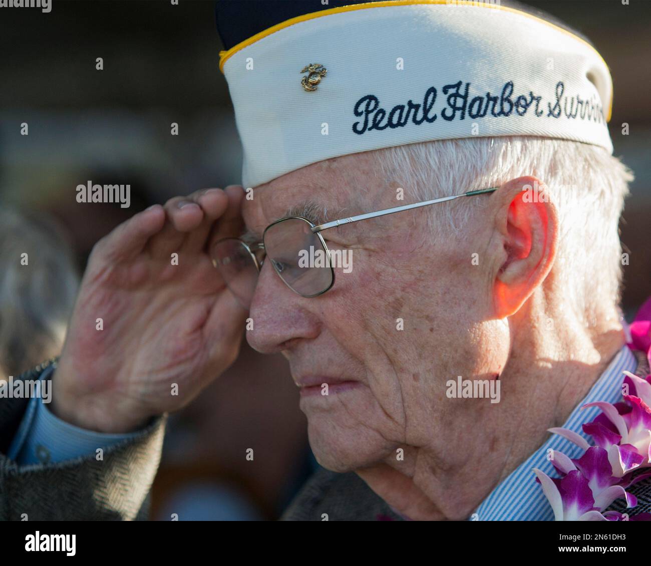 Pearl Harbor survivor John R. Stevens salutes the flag at the start of ...