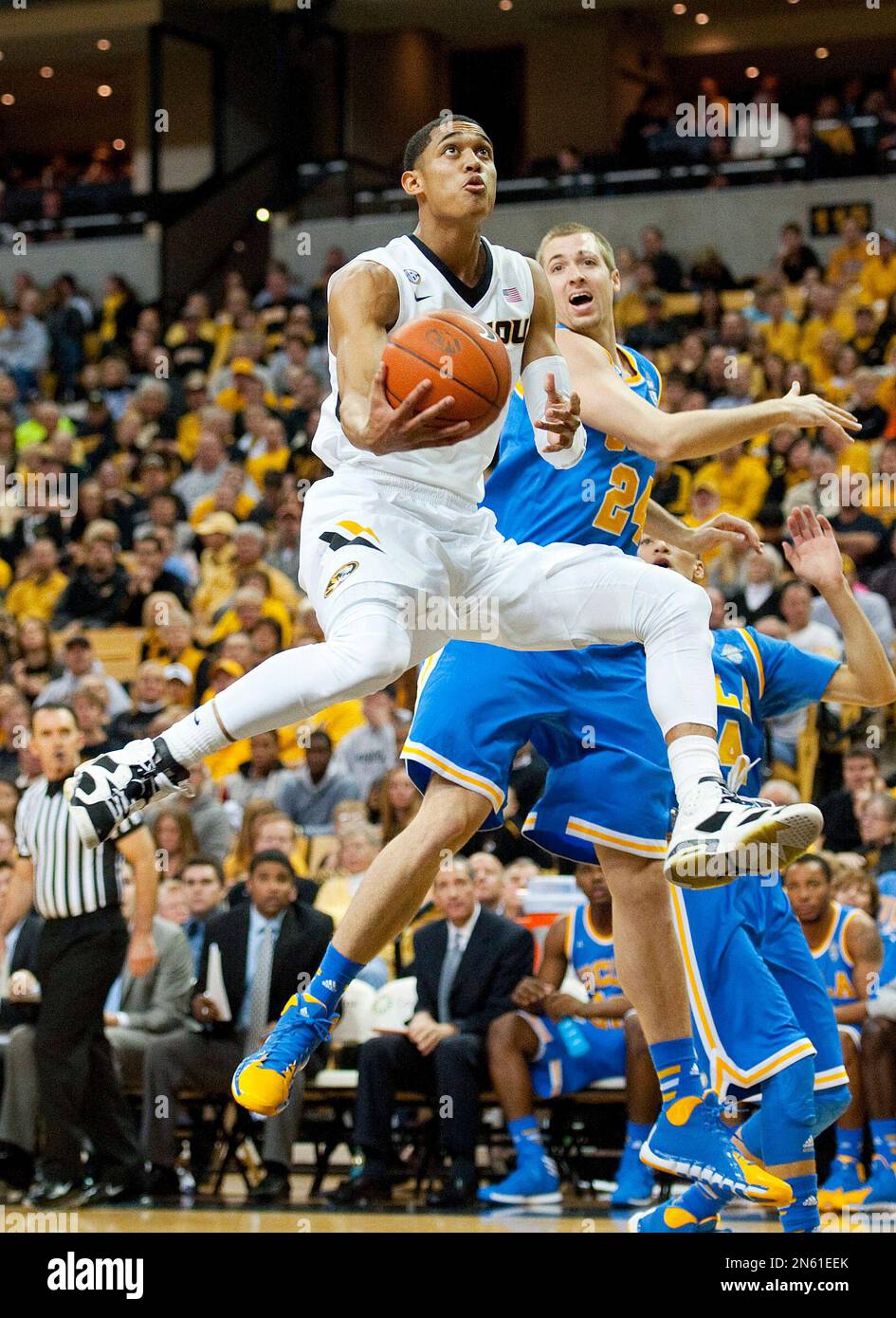 Missouri's Jordan Clarkson, left, shoots as he drives past UCLA's ...