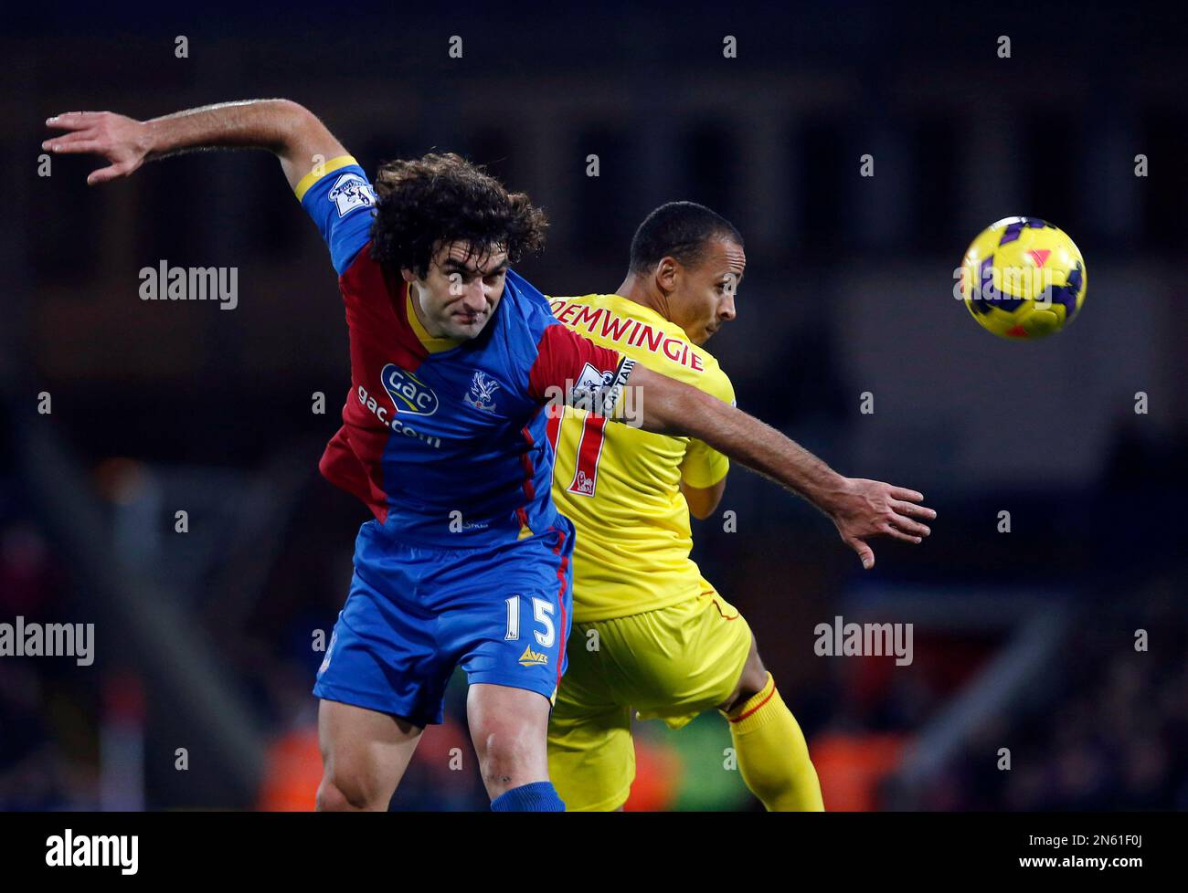 Crystal Palace's Mile Jedinak, left, competes for the ball with Cardiff ...