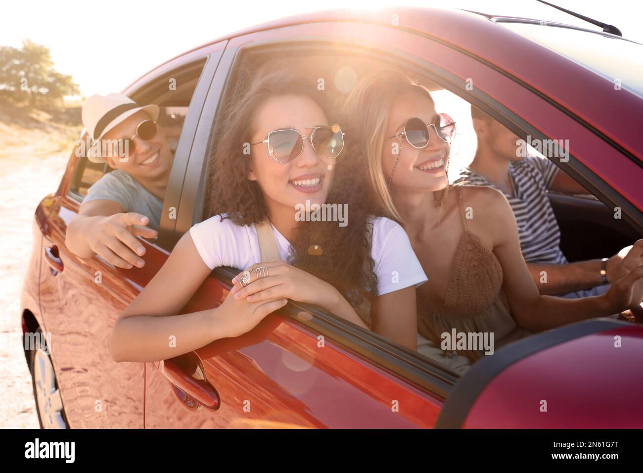 Happy friends together in car on road trip Stock Photo - Alamy