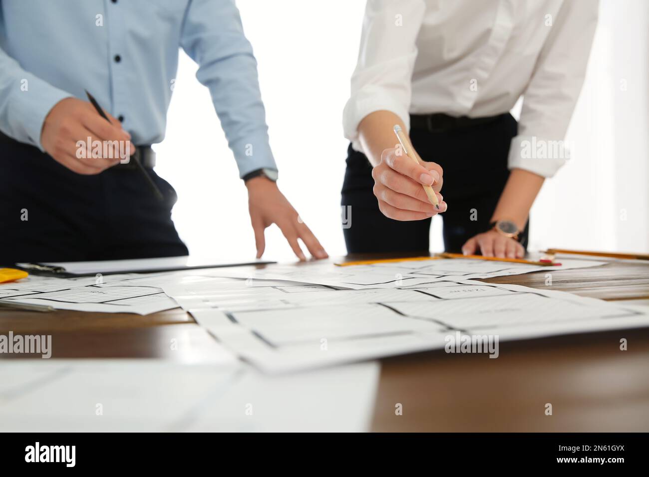 People working with construction drawings at table, closeup Stock Photo ...