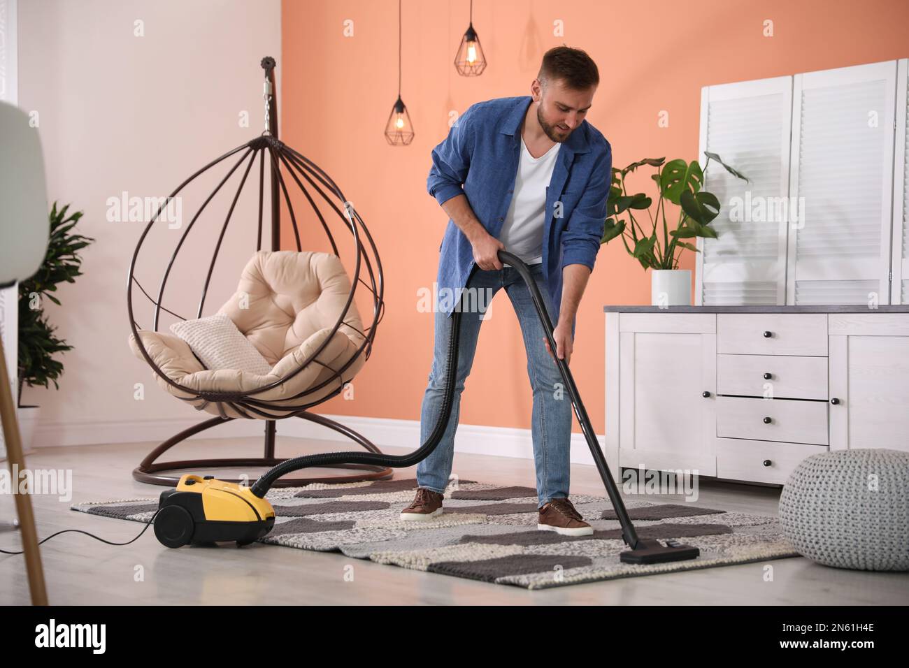 Adult male using vacuum cleaner hi-res stock photography and images - Alamy