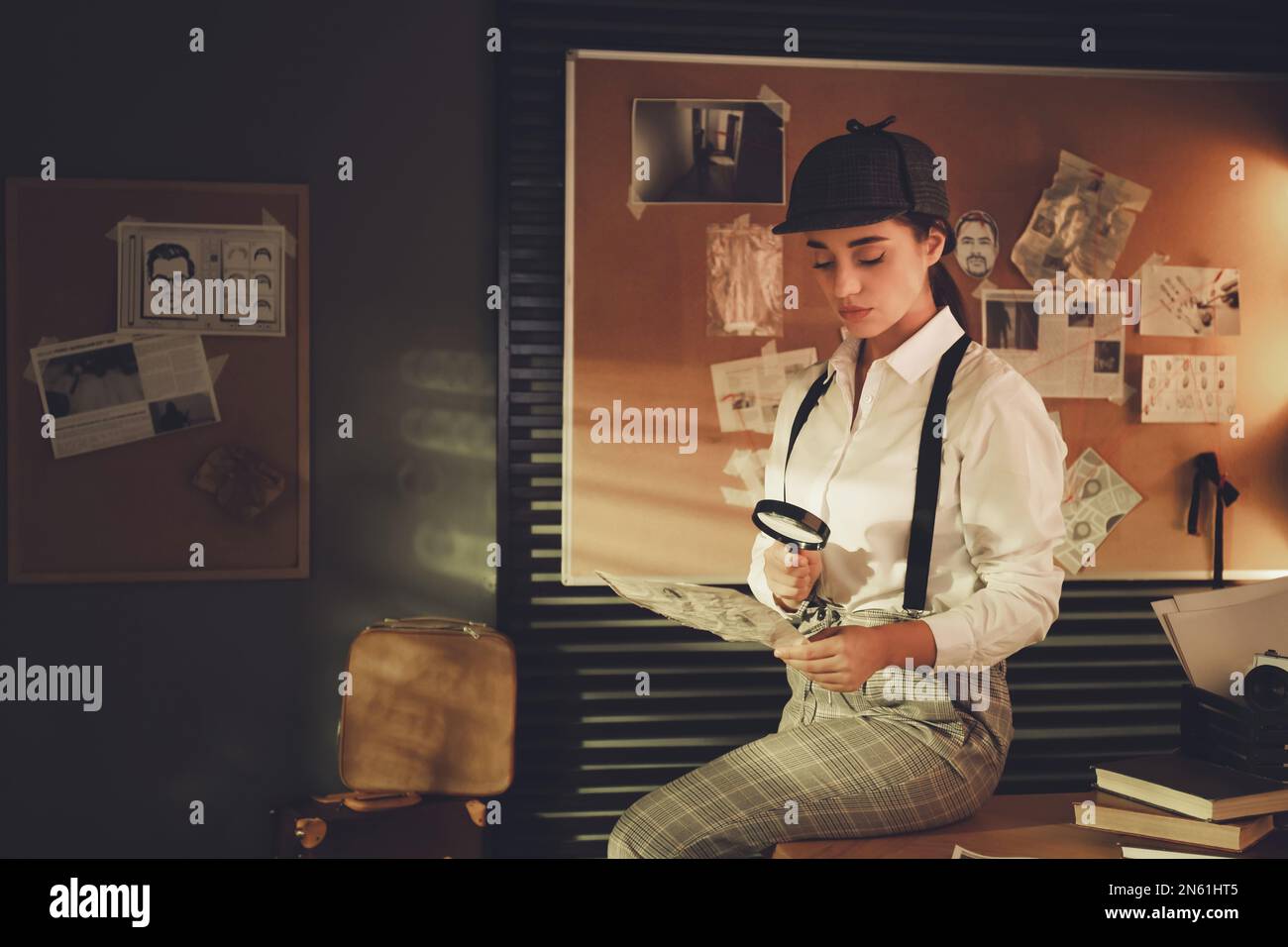 Old fashioned detective with magnifying glass and document in office ...