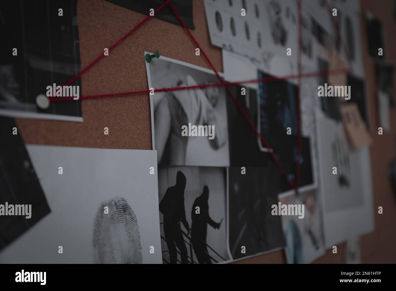 Detective board with crime scene photos, stickers, clues and red thread ...