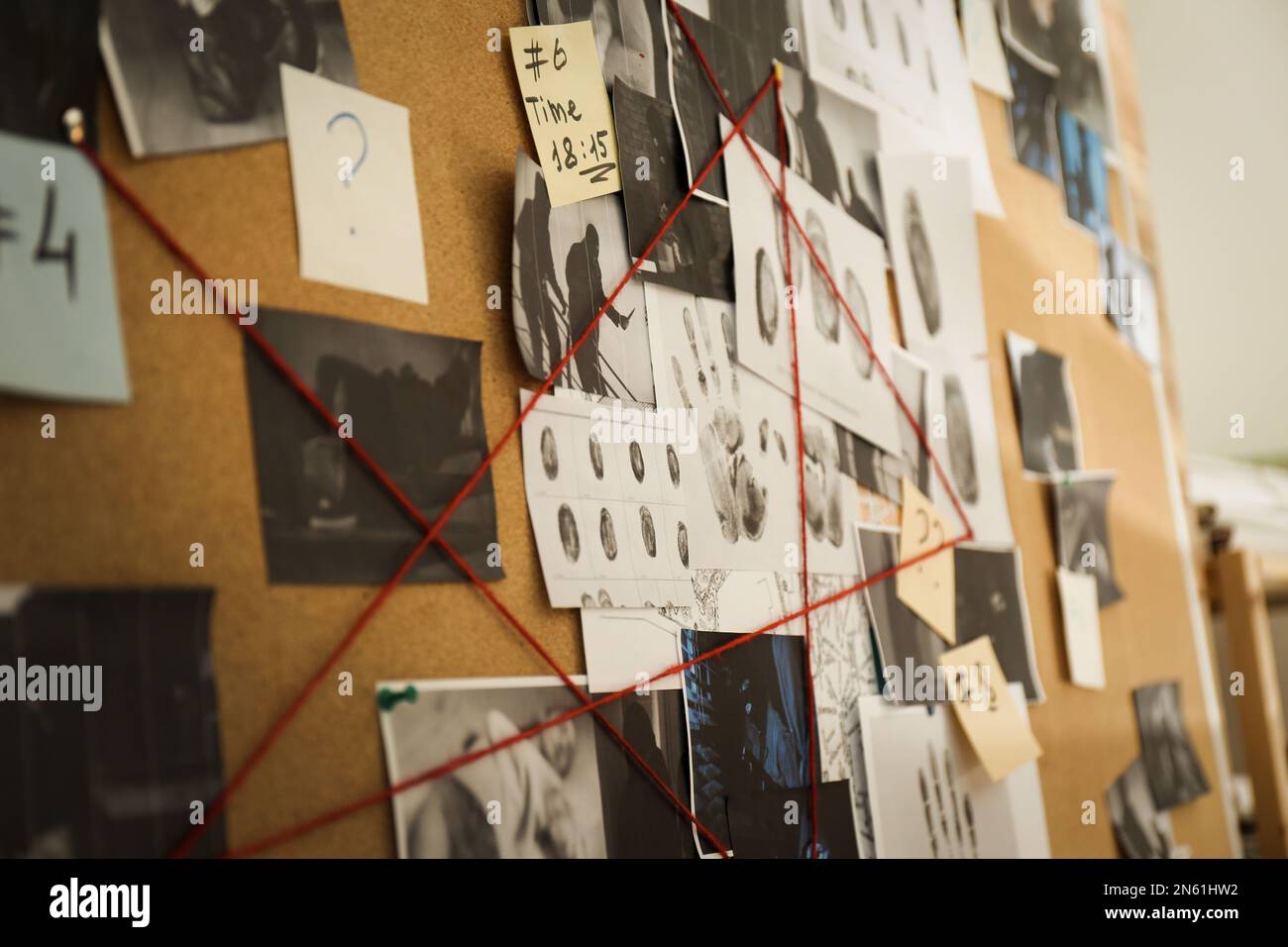 Detective board with crime scene photos, stickers, clues and red thread ...