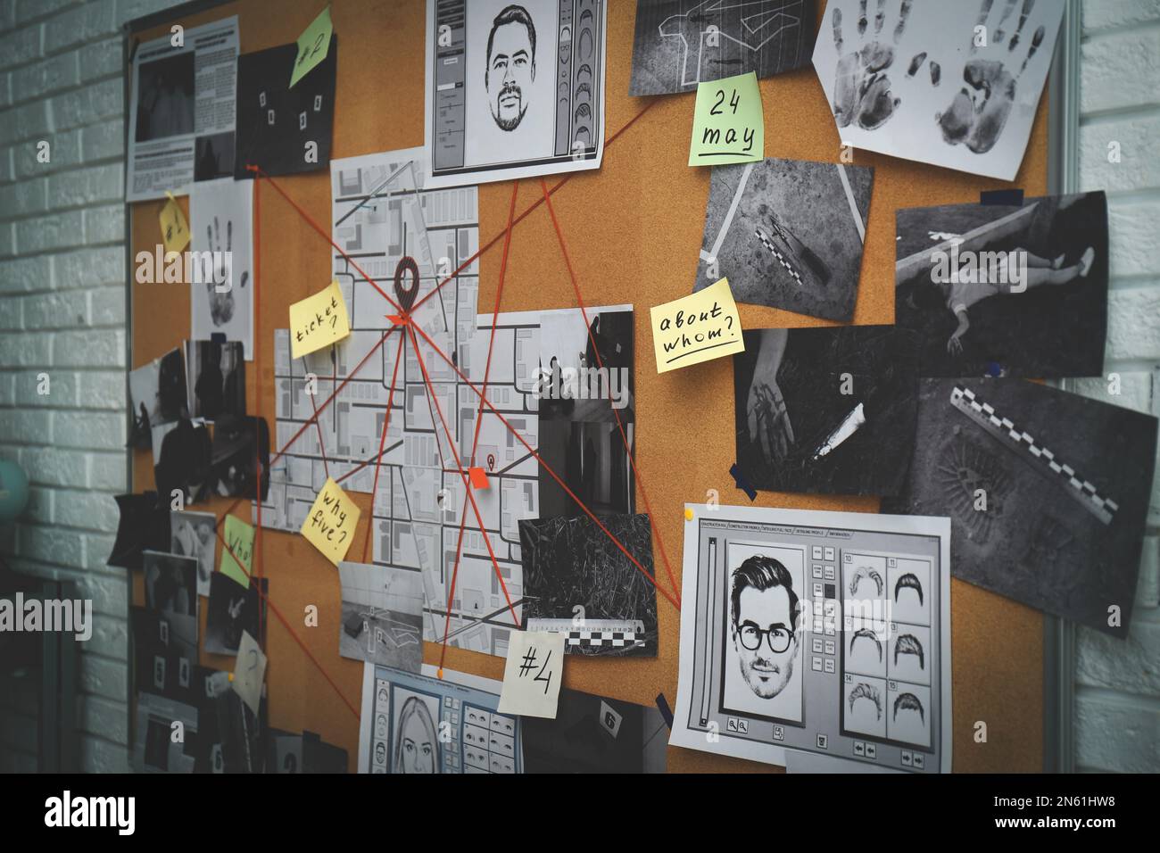 Detective board with stickers, photos, map and clues connected by red ...