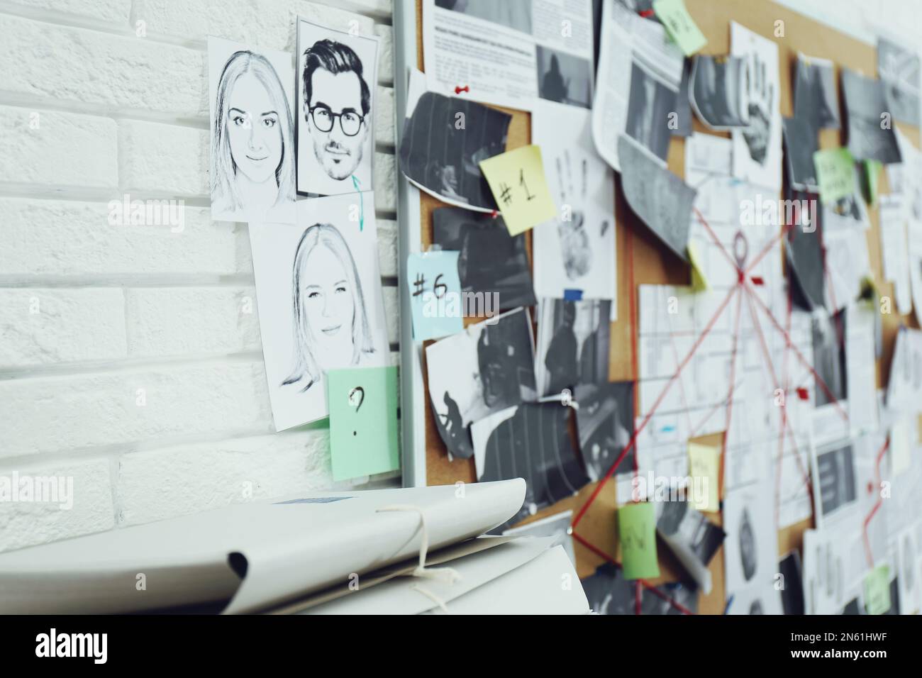 Investigation board on white brick wall in detective office Stock Photo ...