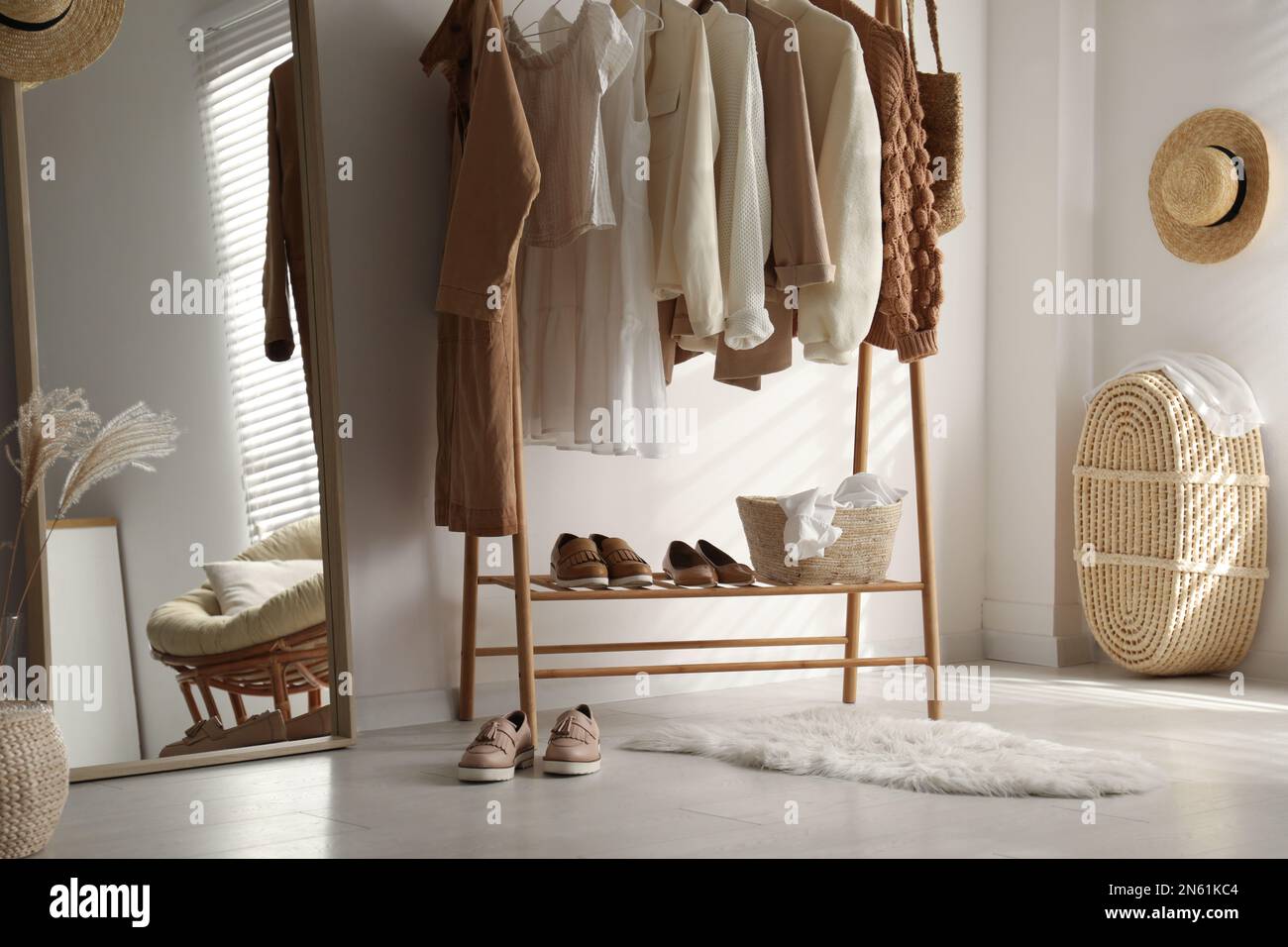 Rack with stylish women's clothes in dressing room. Modern interior ...