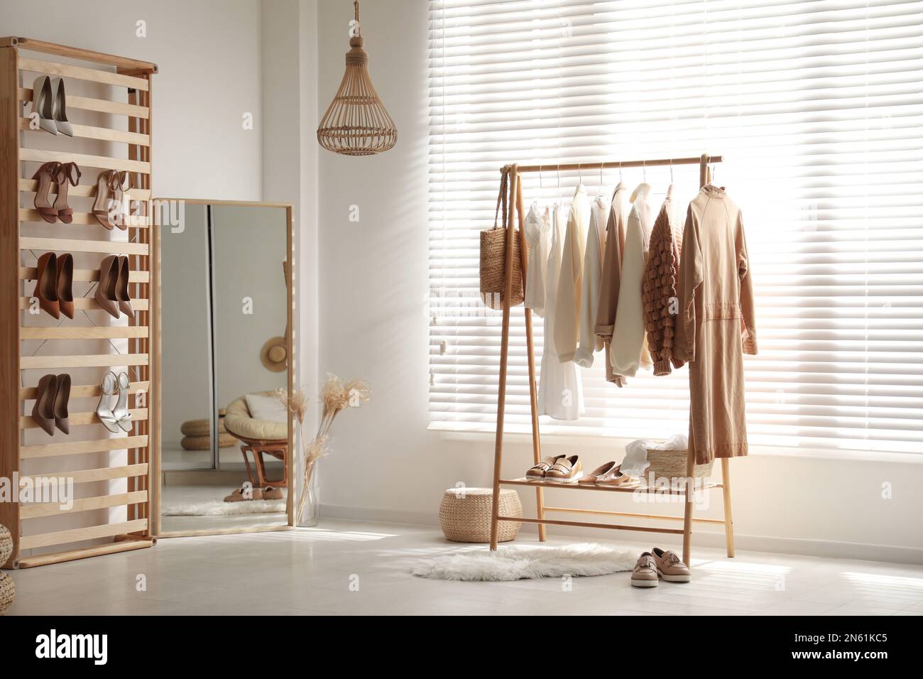 Modern dressing room interior with racks of stylish women's clothes and ...