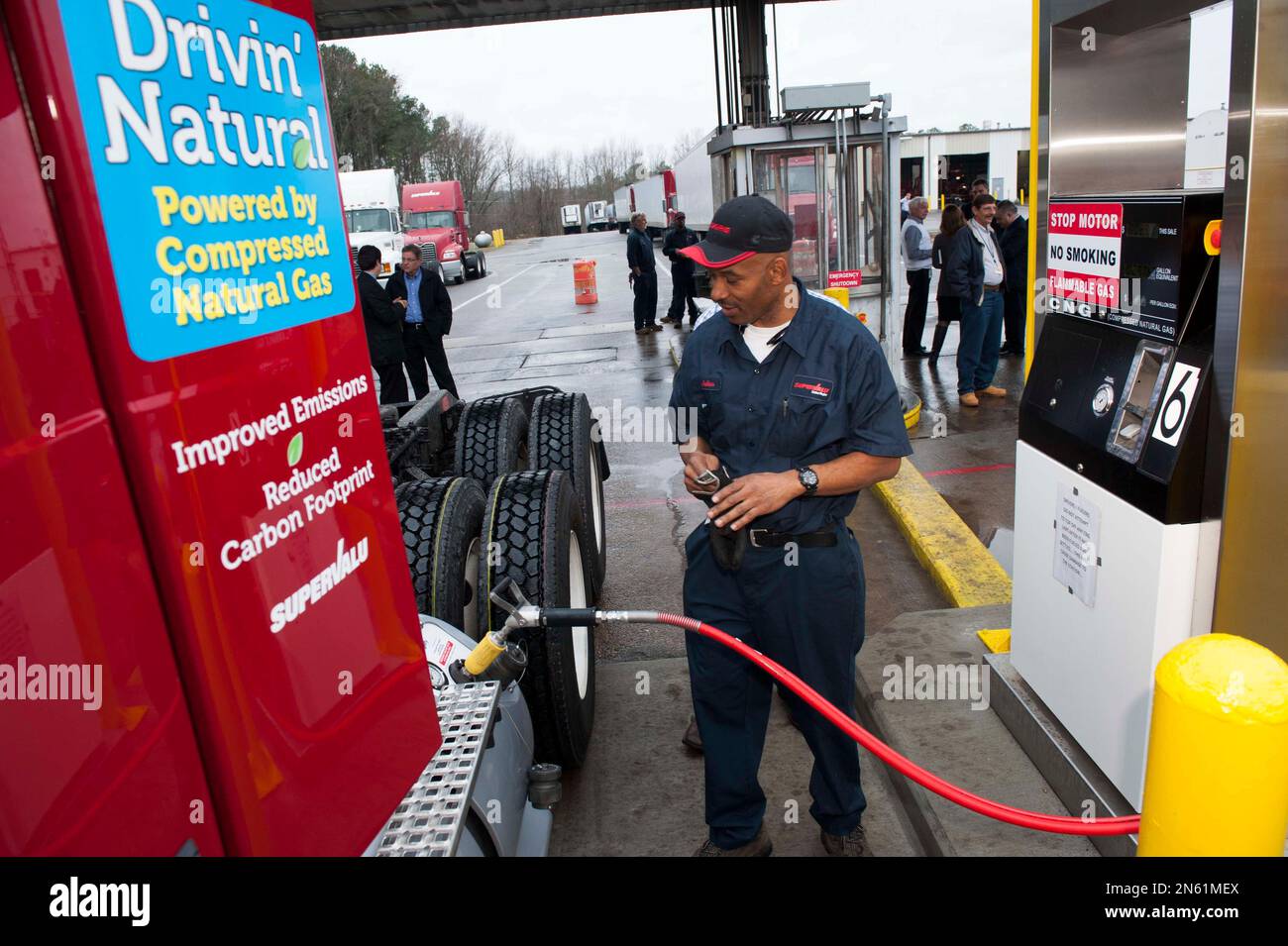 SUPERVALU employee Julius Tillman fills the company trucks with CNG as ...