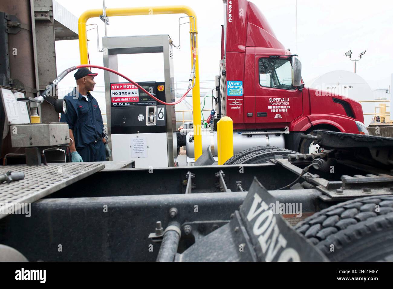 SUPERVALU employee Julius Tillman fills the company trucks with CNG as ...