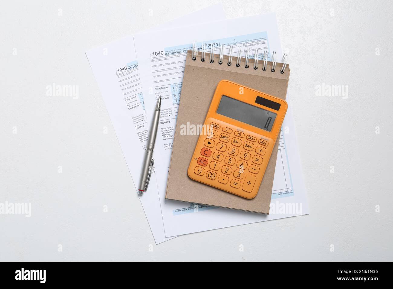 Calculator, documents and stationery on white table, flat lay. Tax ...
