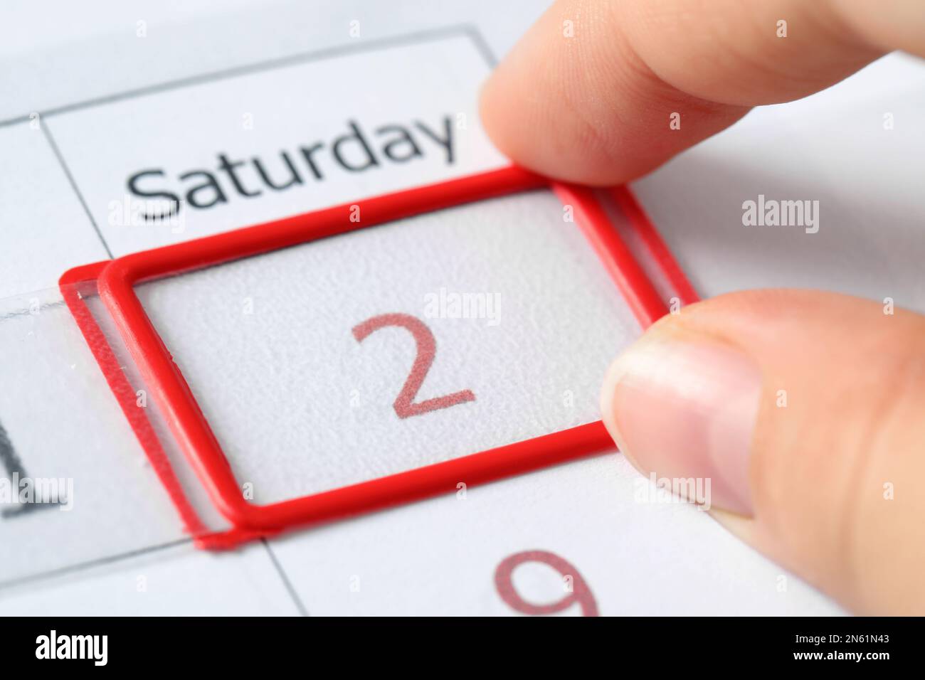 Woman moving date slider on calendar onto February 2nd, closeup ...