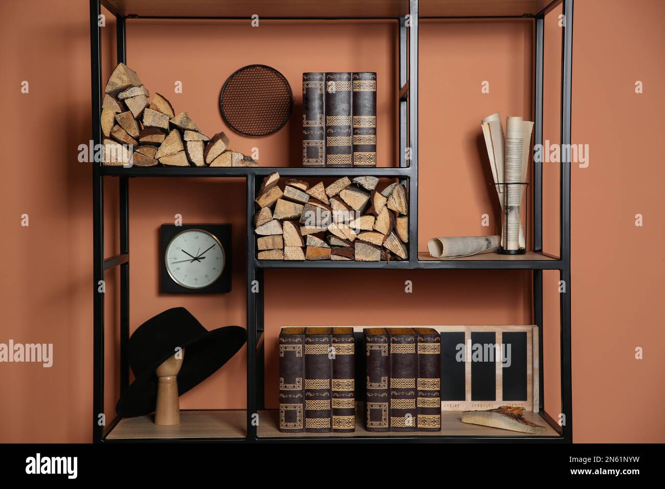 Stylish shelving unit with decorative elements near color wall ...