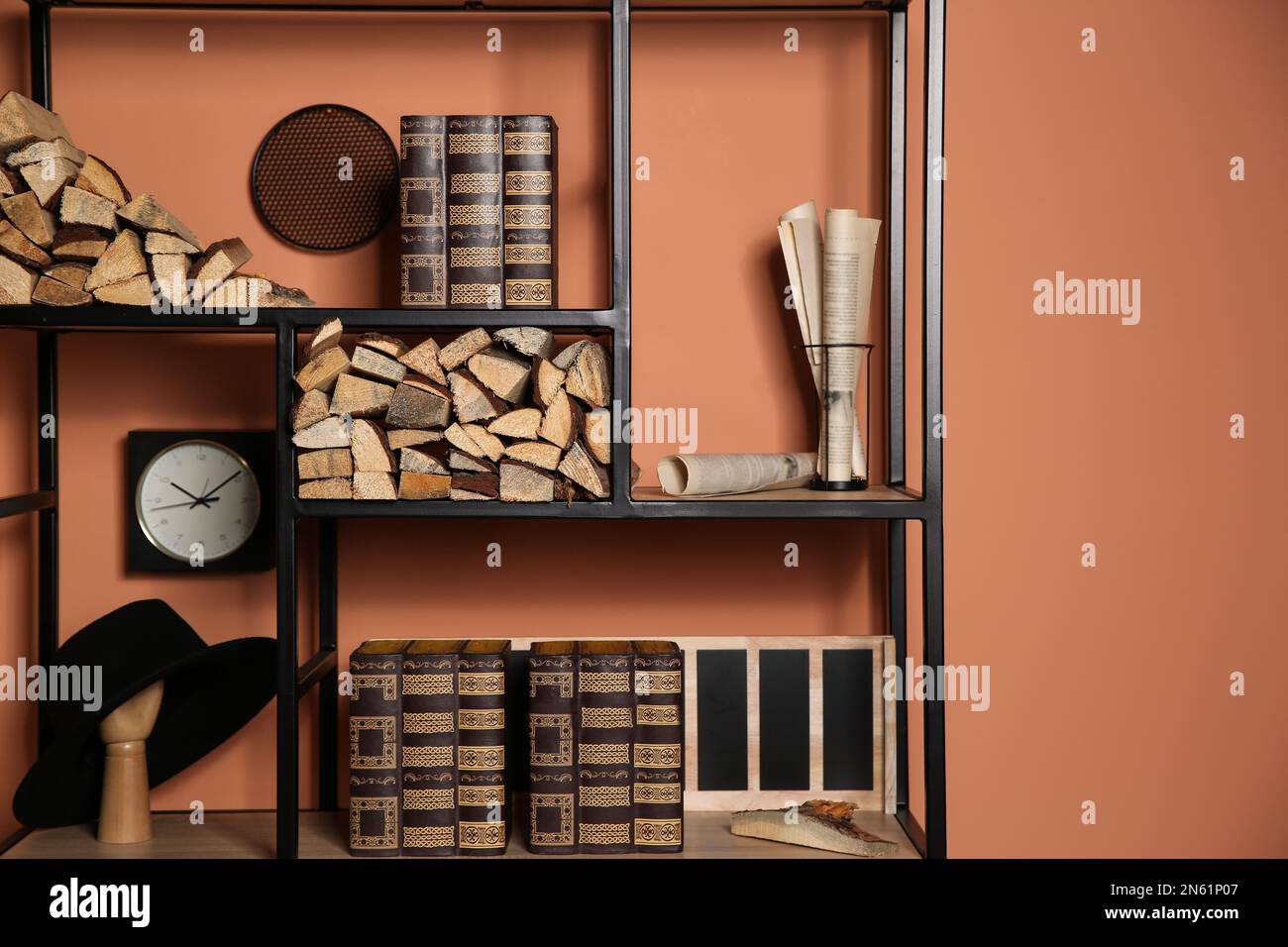 Stylish shelving unit with decorative elements near color wall ...