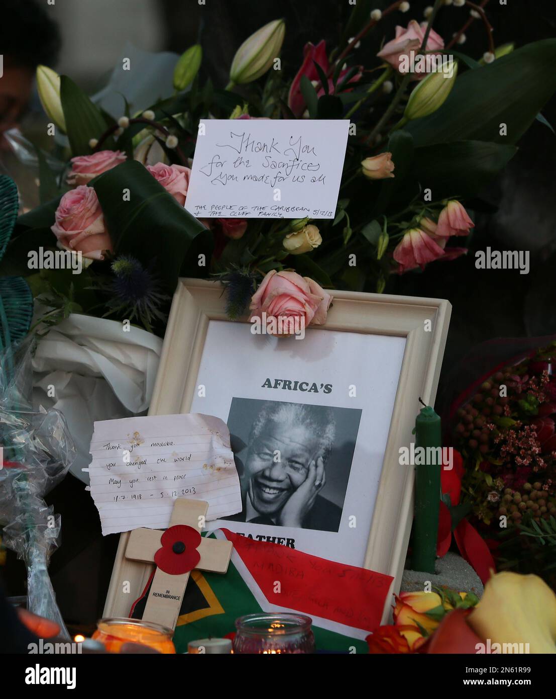 Floral tributes, a framed photograph and candles are laid in memory of ...