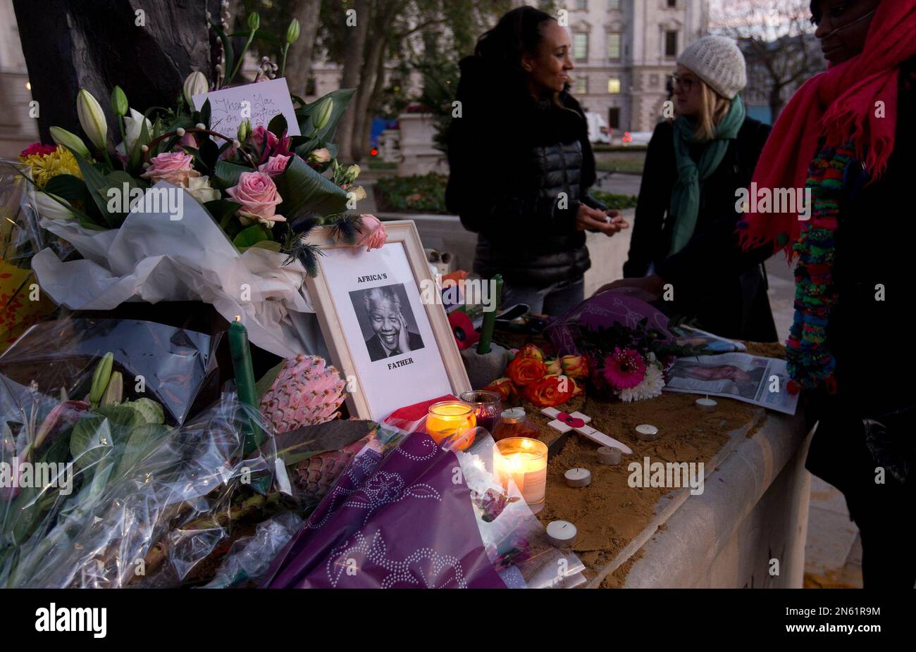 People look at floral tributes laid in memory of former South African ...