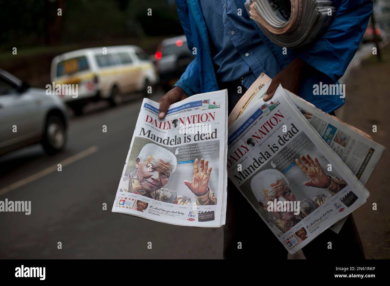 A newspaper seller displays copies of Kenya's Daily Nation, which ...
