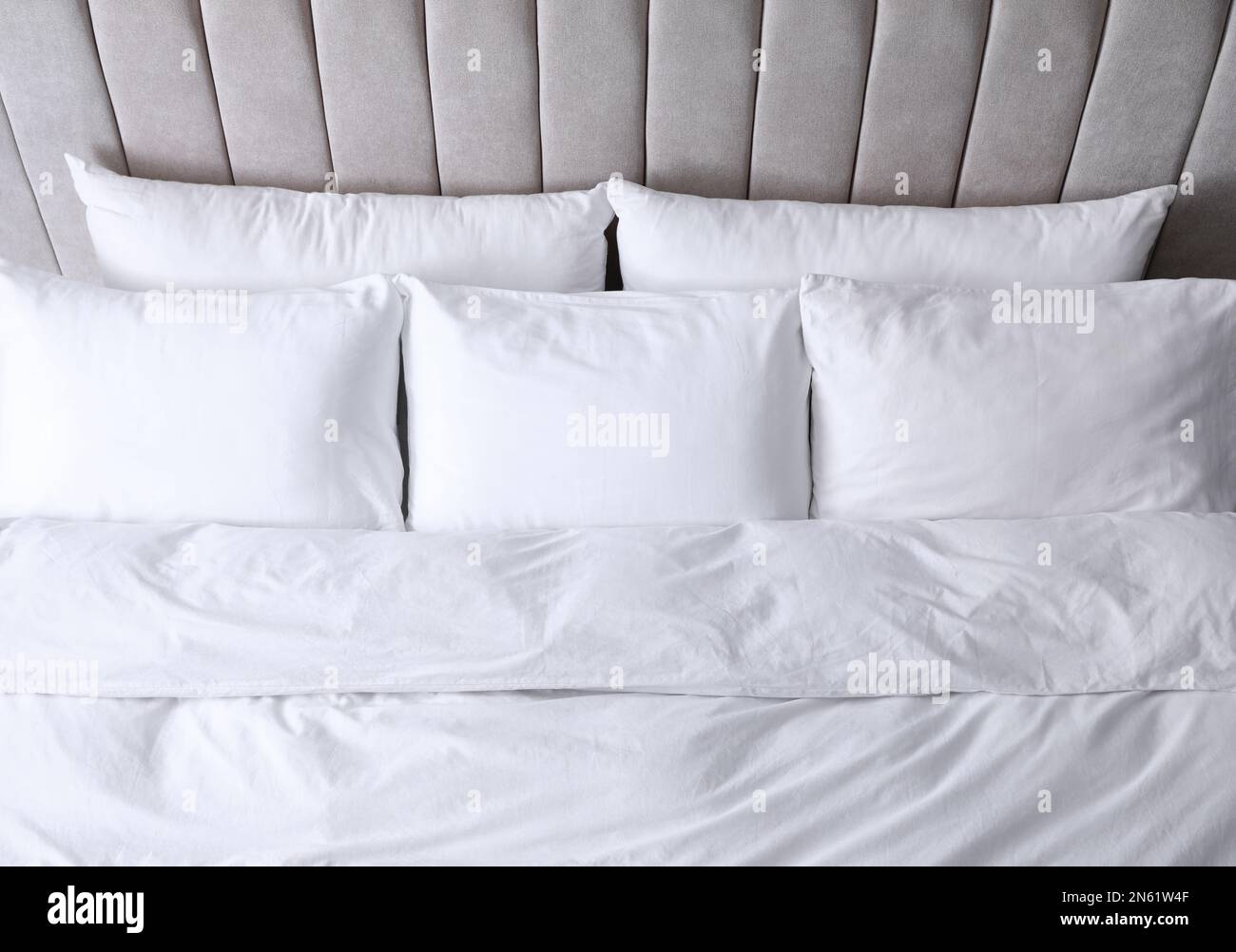 Comfortable bed with soft pillows, above view Stock Photo - Alamy