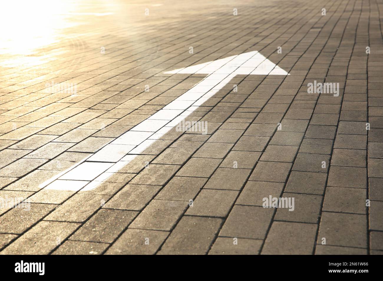 White painted arrow marking on road outdoors Stock Photo - Alamy