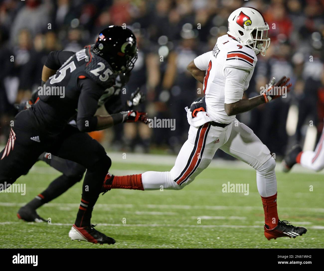 Louisville wide receiver DeVante Parker, right, runs past Cincinnati ...