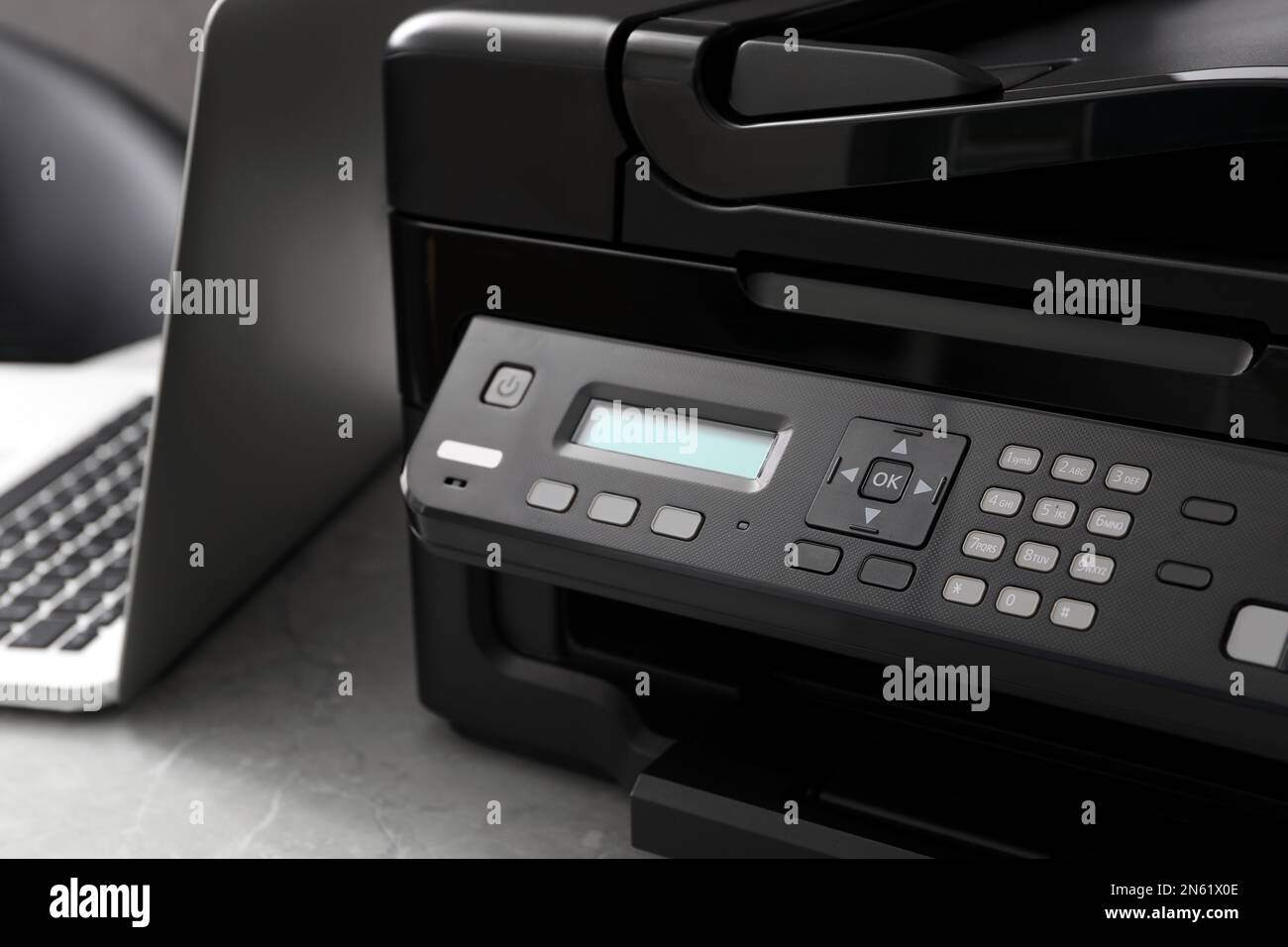 New modern printer and laptop on grey table, closeup Stock Photo - Alamy