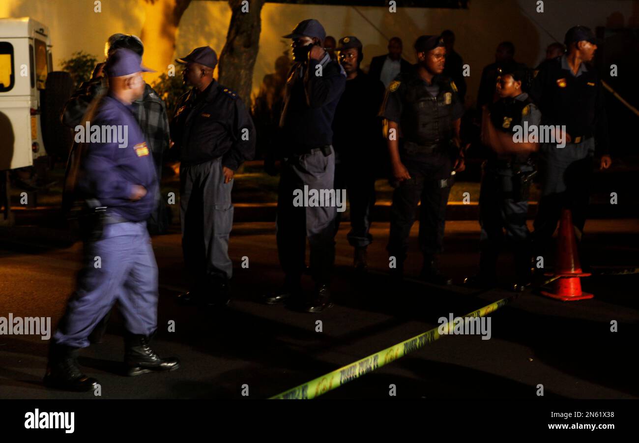 Police keep watch outside the home of former president Nelson Mandela ...