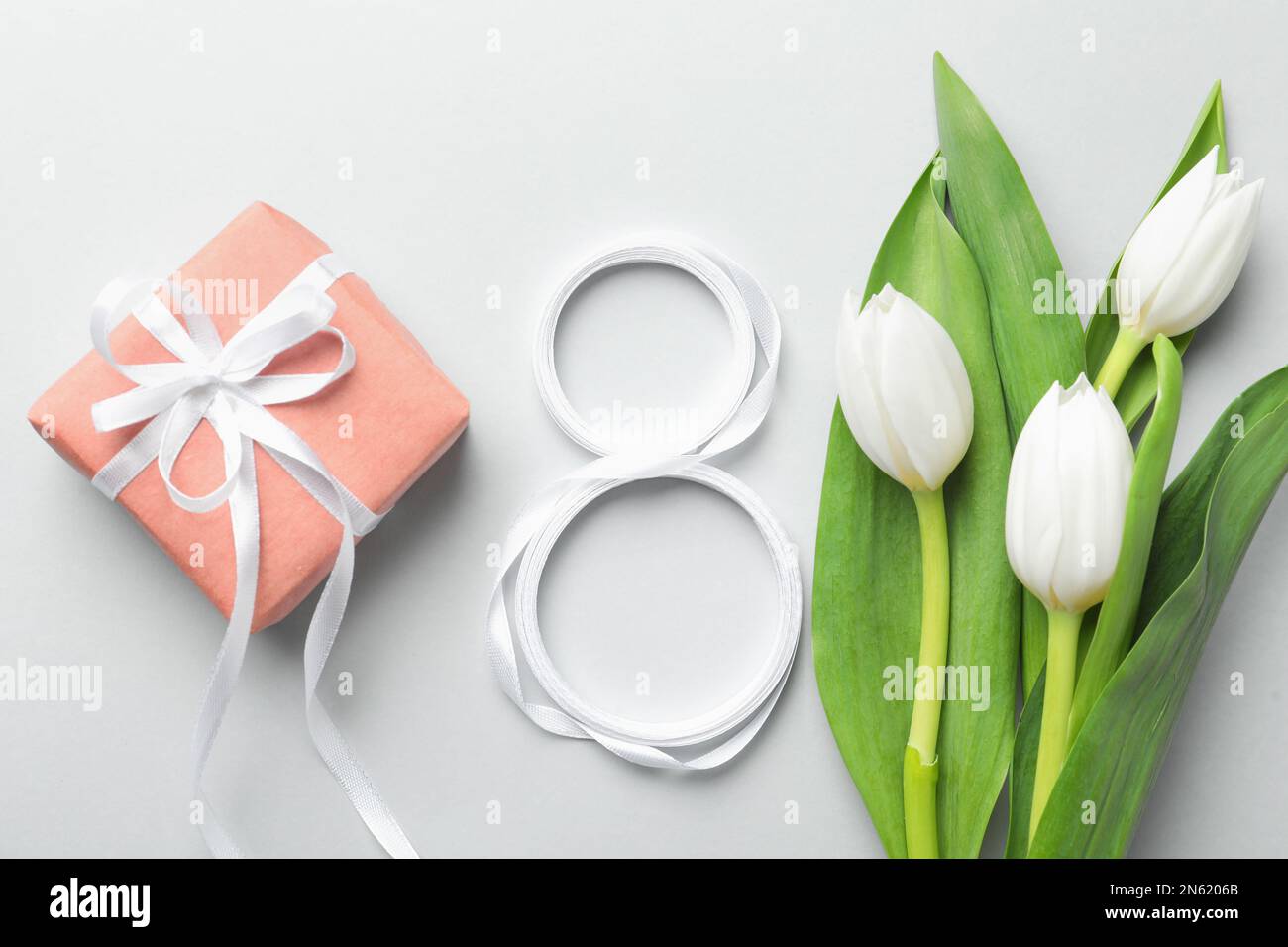 8 March card design with tulips and gift on light grey background, flat ...