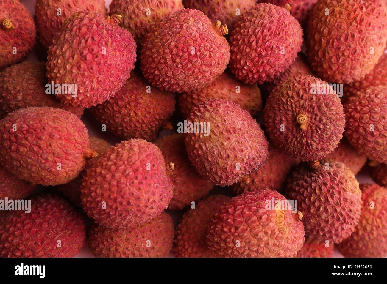 Pile of fresh ripe lychees as background, top view Stock Photo - Alamy