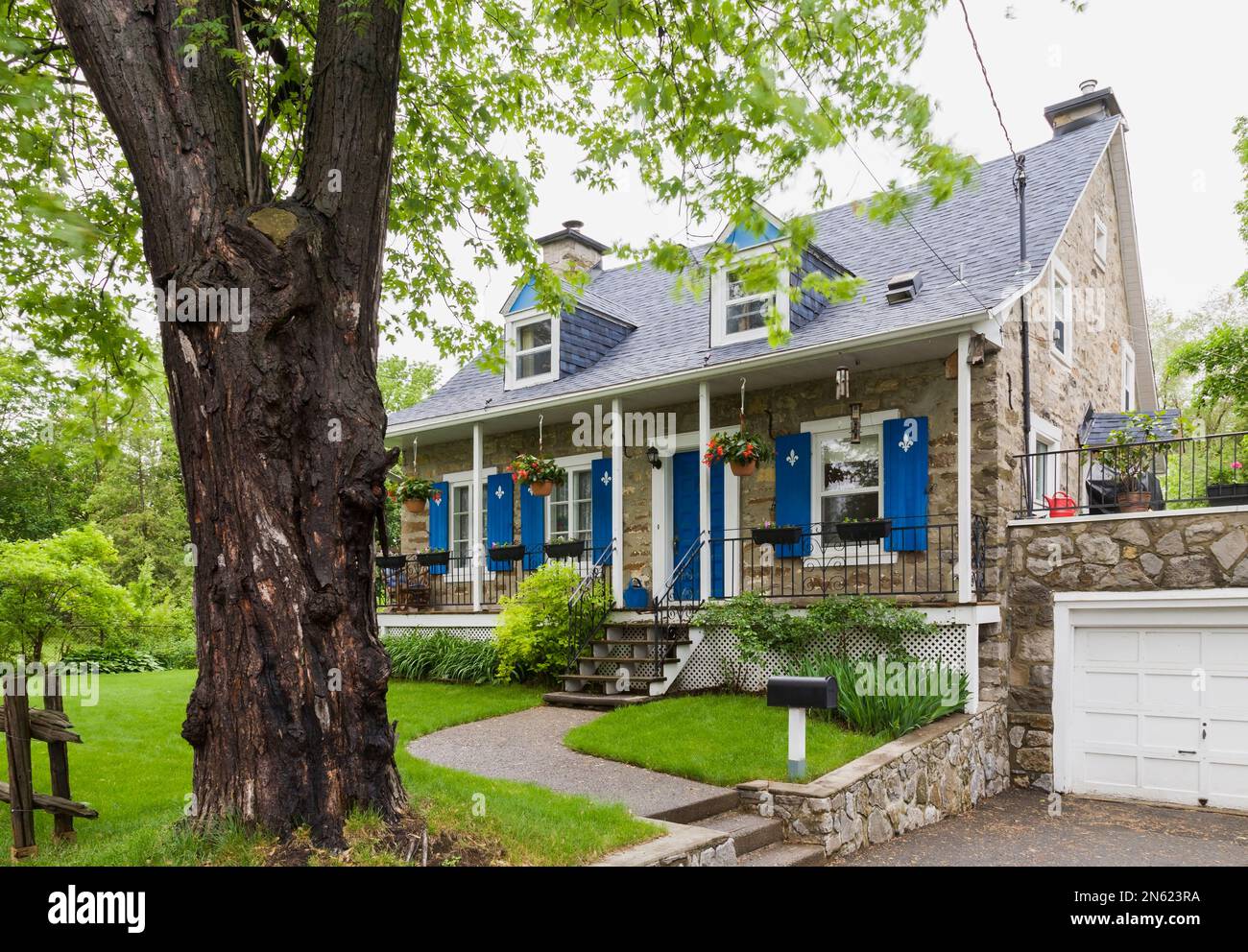 Old 1839 blue with white trim fieldstone house facade in spring Stock ...
