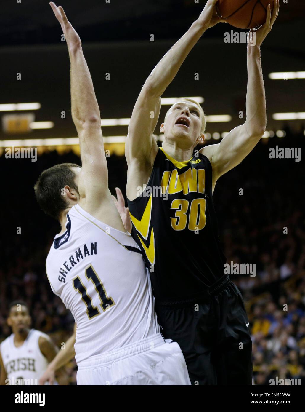 Iowa forward Aaron White, right, shoots over Notre Dame center Garrick ...