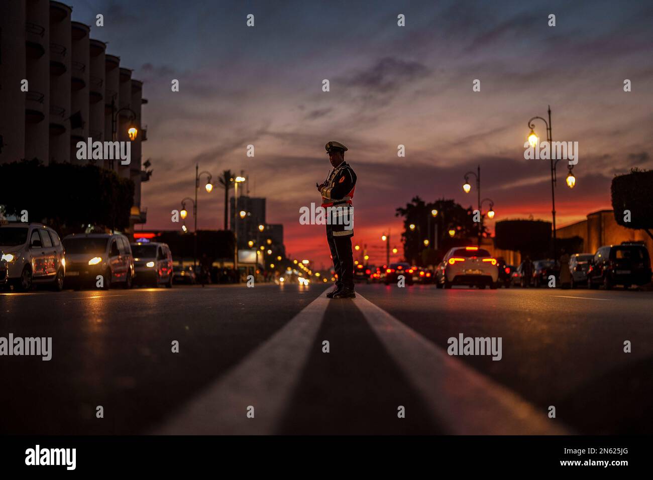 A Moroccan police officer stands as he controls the traffic during the ...