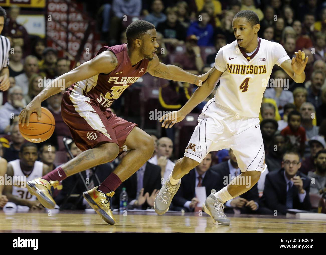 Florida State guard Ian Miller, left, drives against Minnesota guard ...